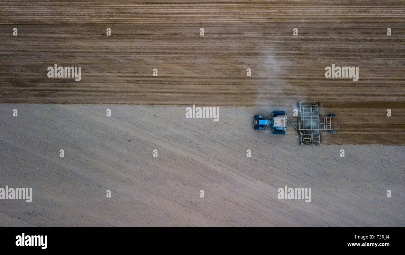 Tractor cultivating field at spring,Tillage is the agricultural ...