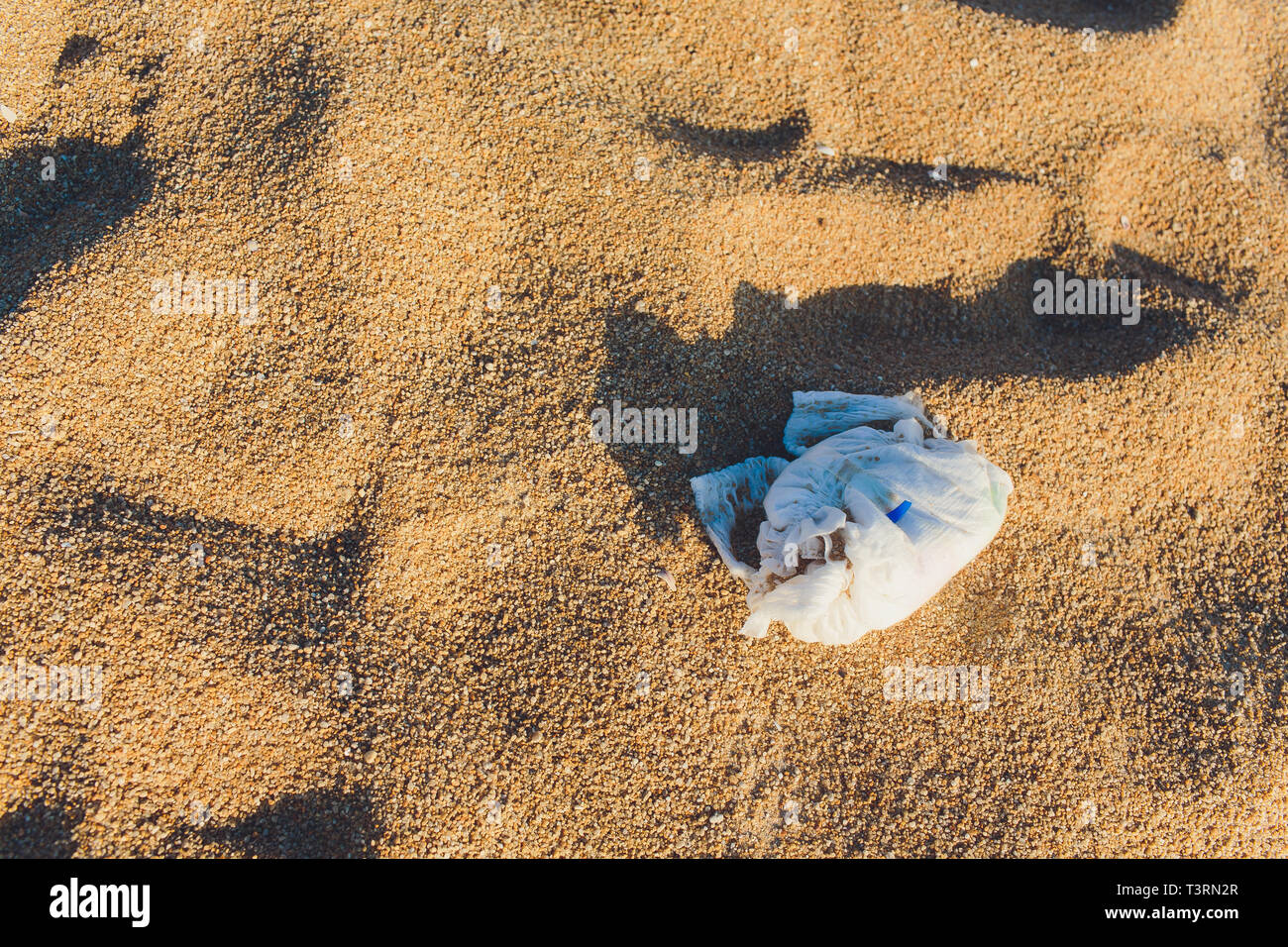 Used baby diaper left unattended at the beach Stock Photo - Alamy