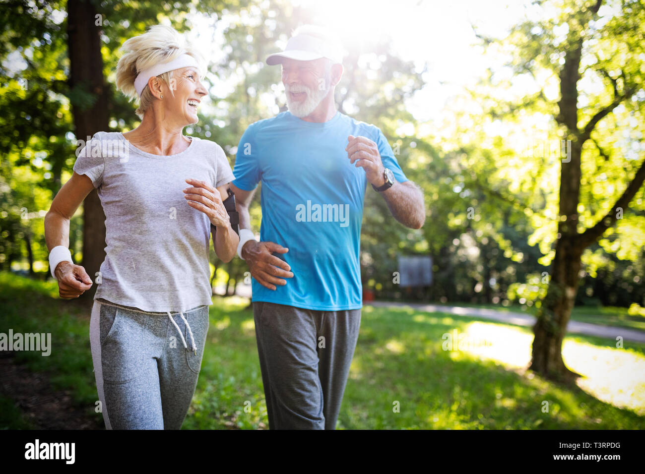 Senior couple jogging and running outdoors in nature Stock Photo - Alamy