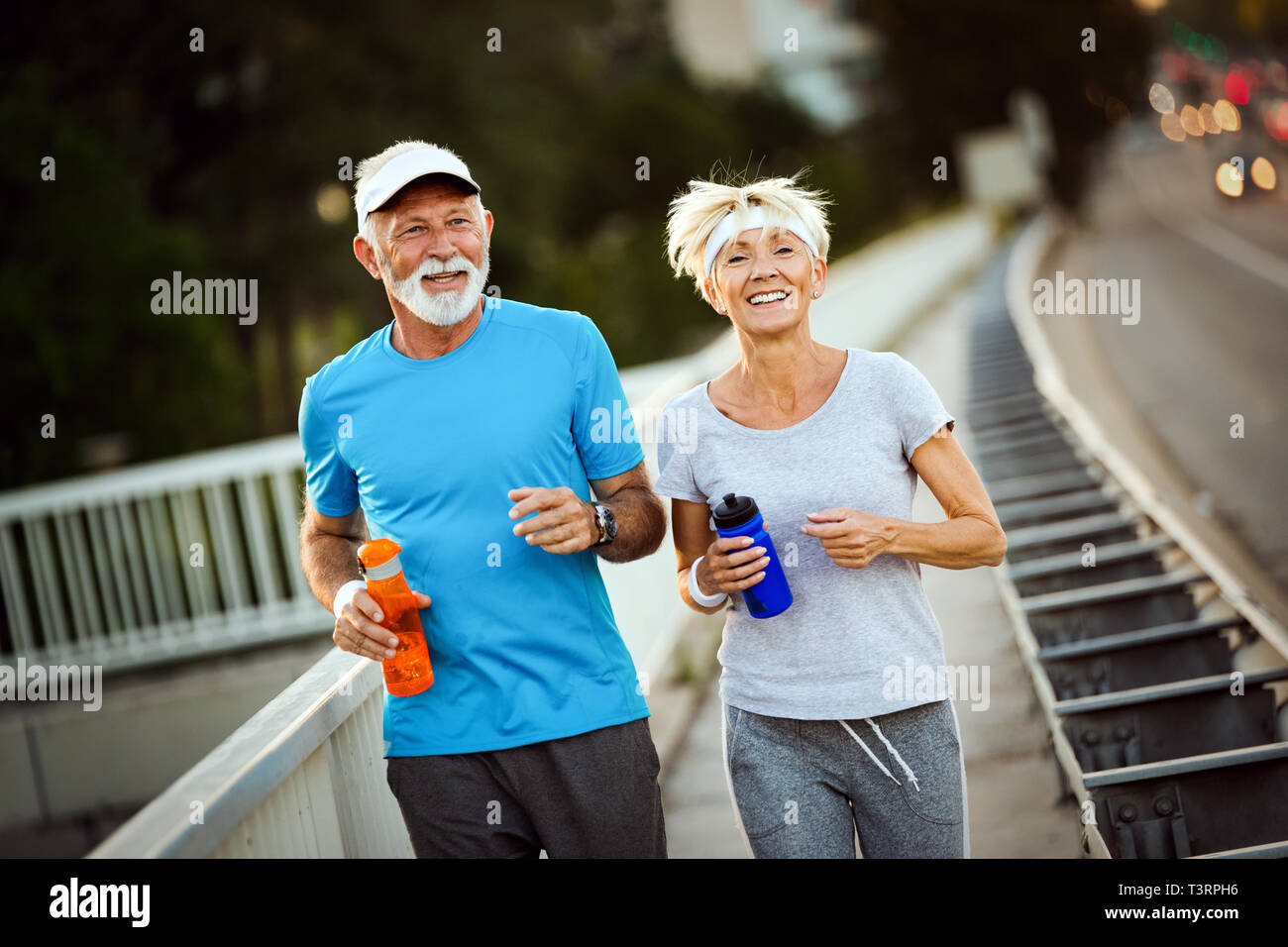 Happy senior couple staying fit by sport running Stock Photo - Alamy