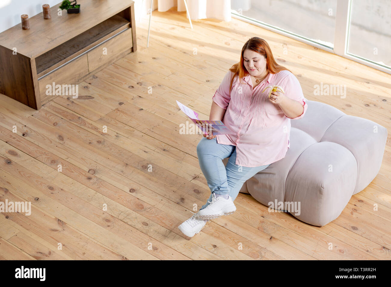 Top view of a happy overweight woman reading Stock Photo - Alamy