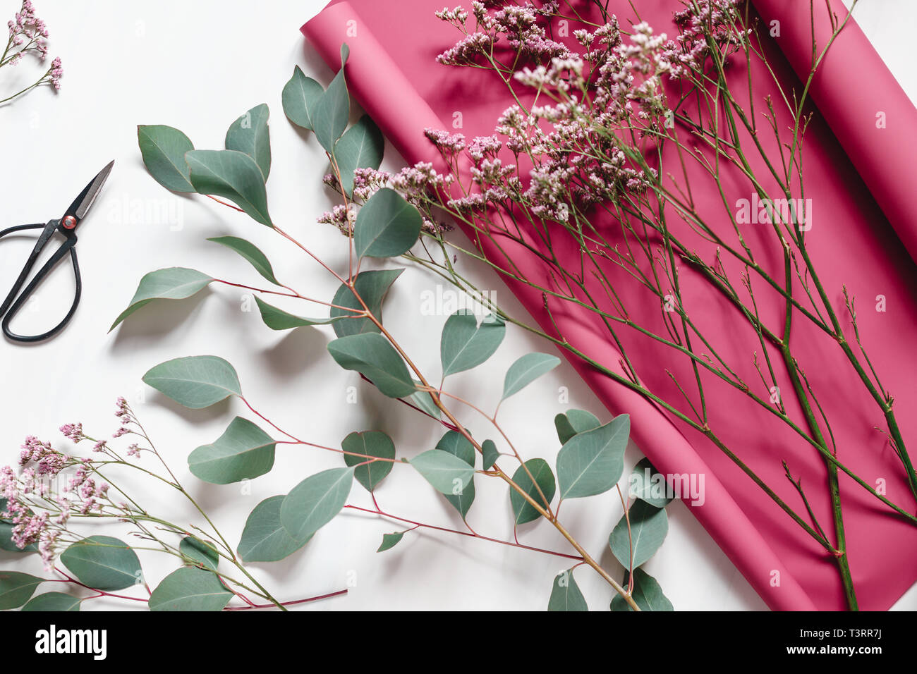 Flat lay abstract composition of spring flowers and eucalyptus branch ...