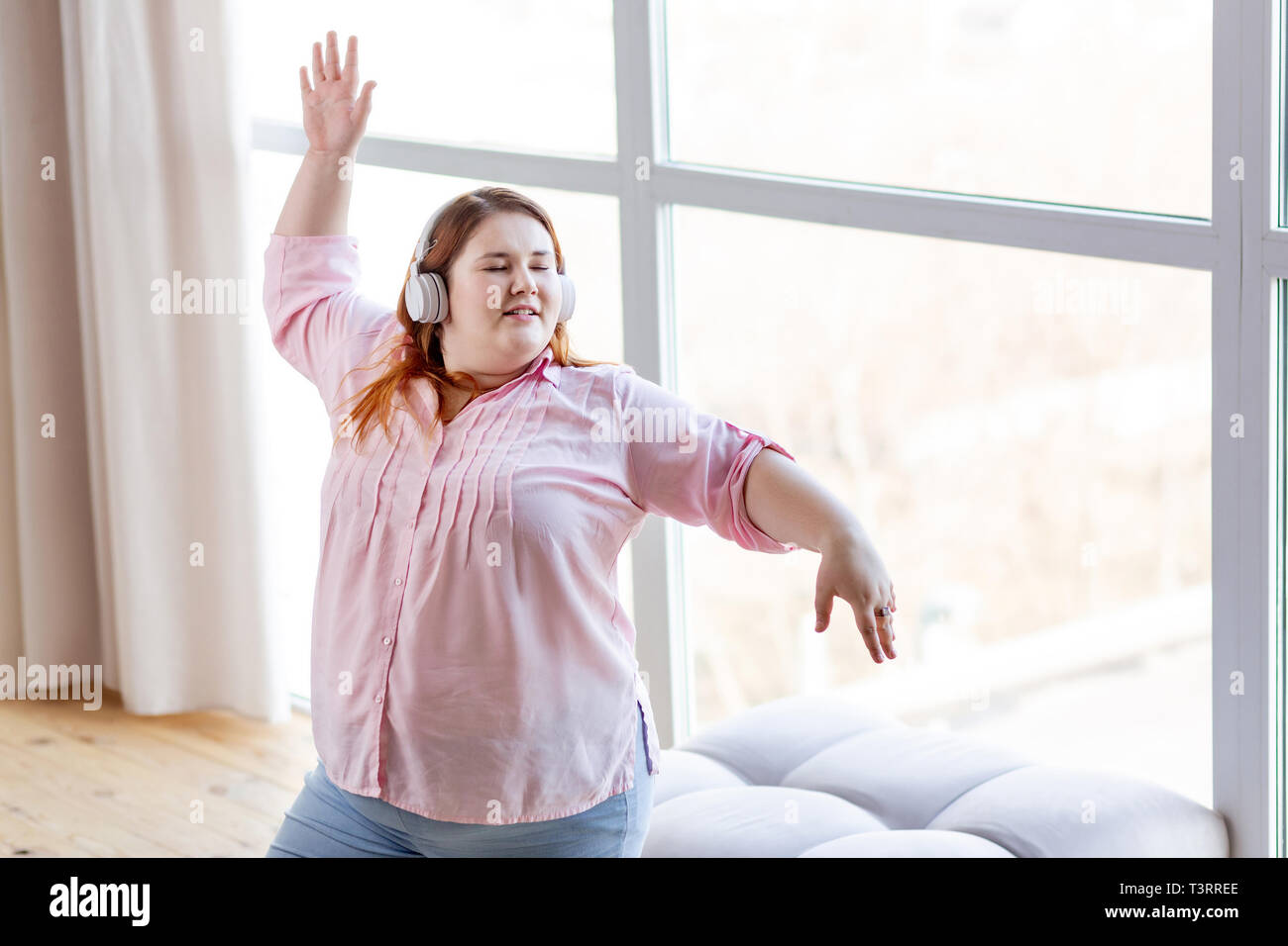 Happy positive woman dancing to her favourite music Stock Photo - Alamy