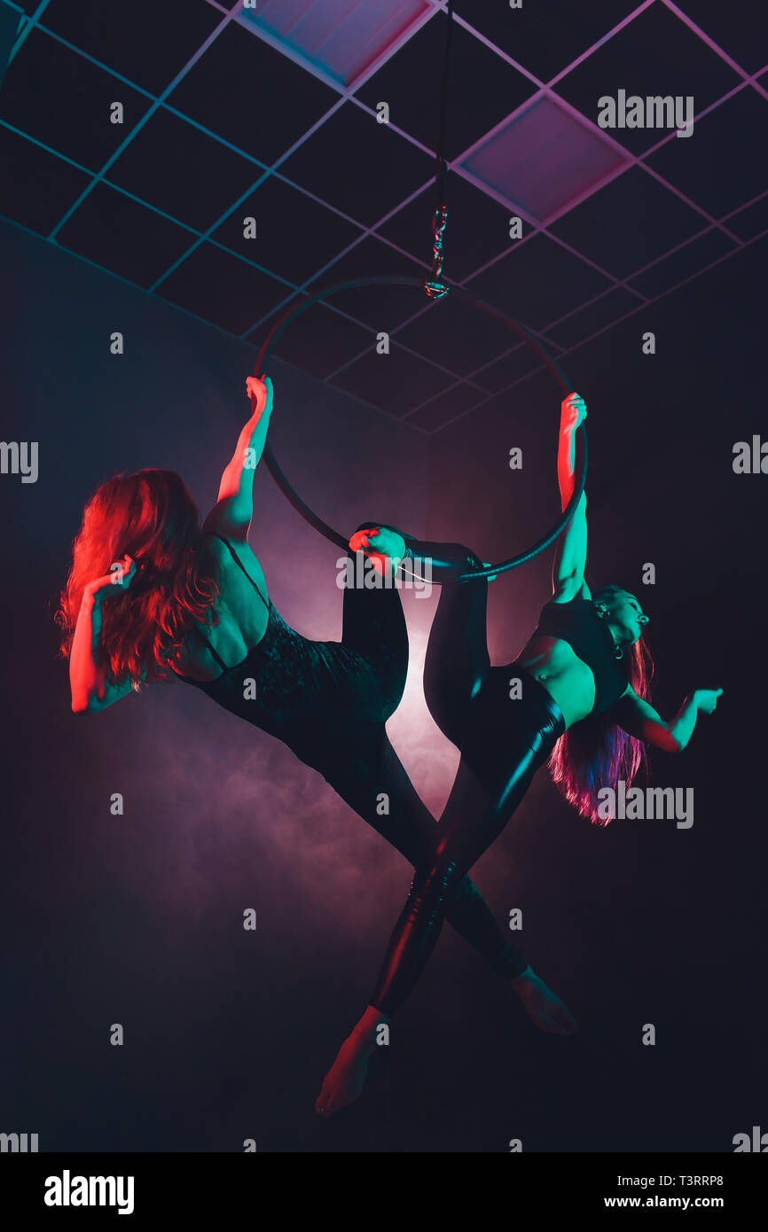 Aerial acrobat in the ring. A two young girl performs the acrobatic ...