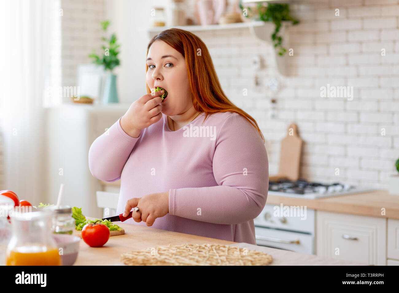 Overweight woman eating hi-res stock photography and images - Alamy