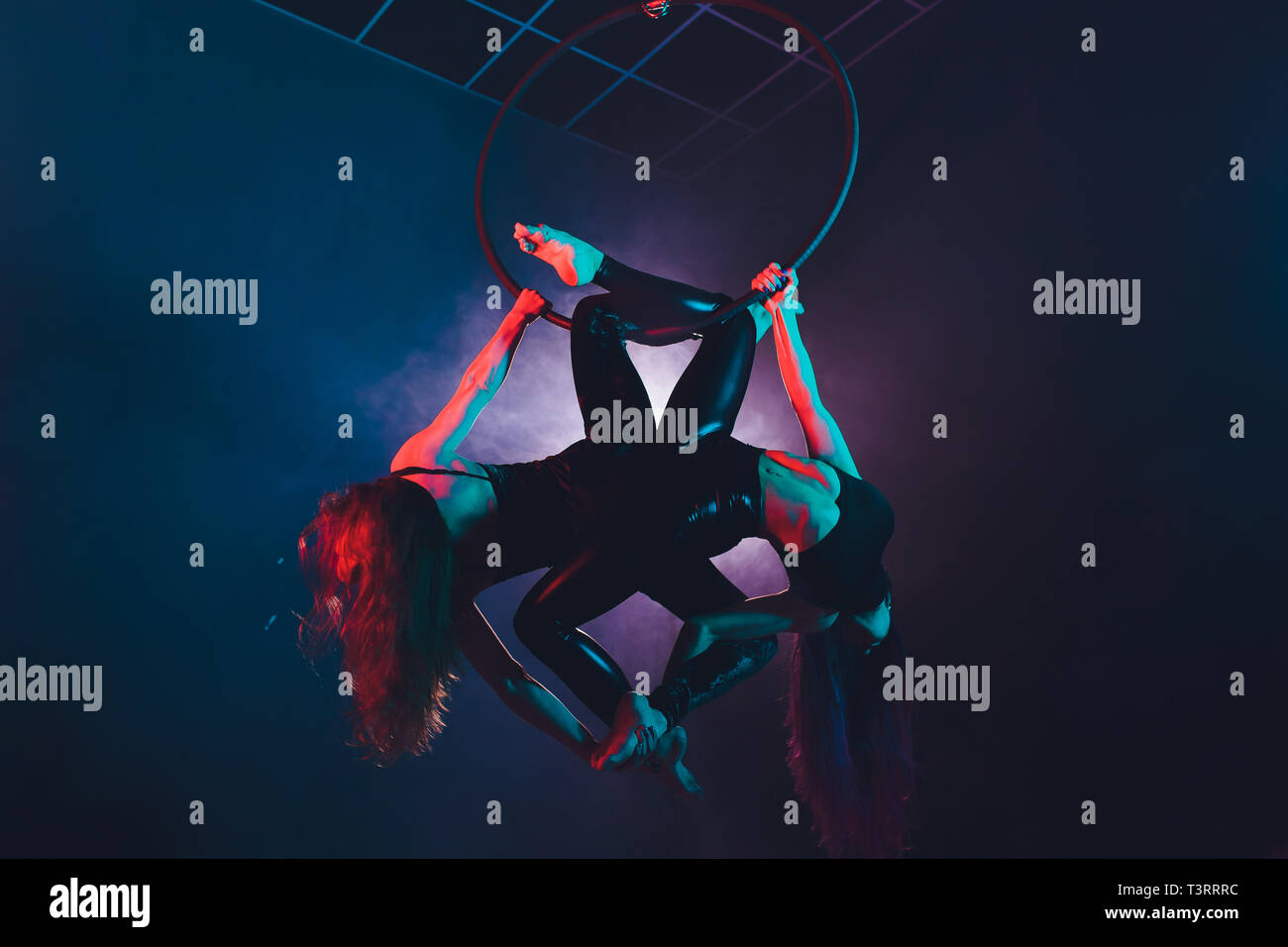 Aerial acrobat in the ring. A two young girl performs the acrobatic ...