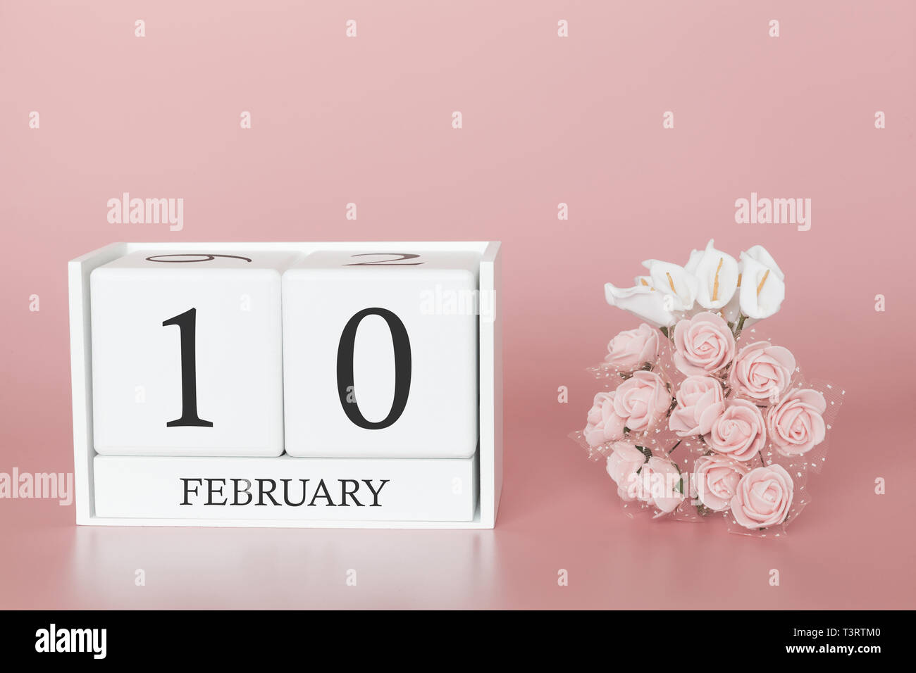 February 10th. Day 10 of month. Calendar cube on modern pink background ...