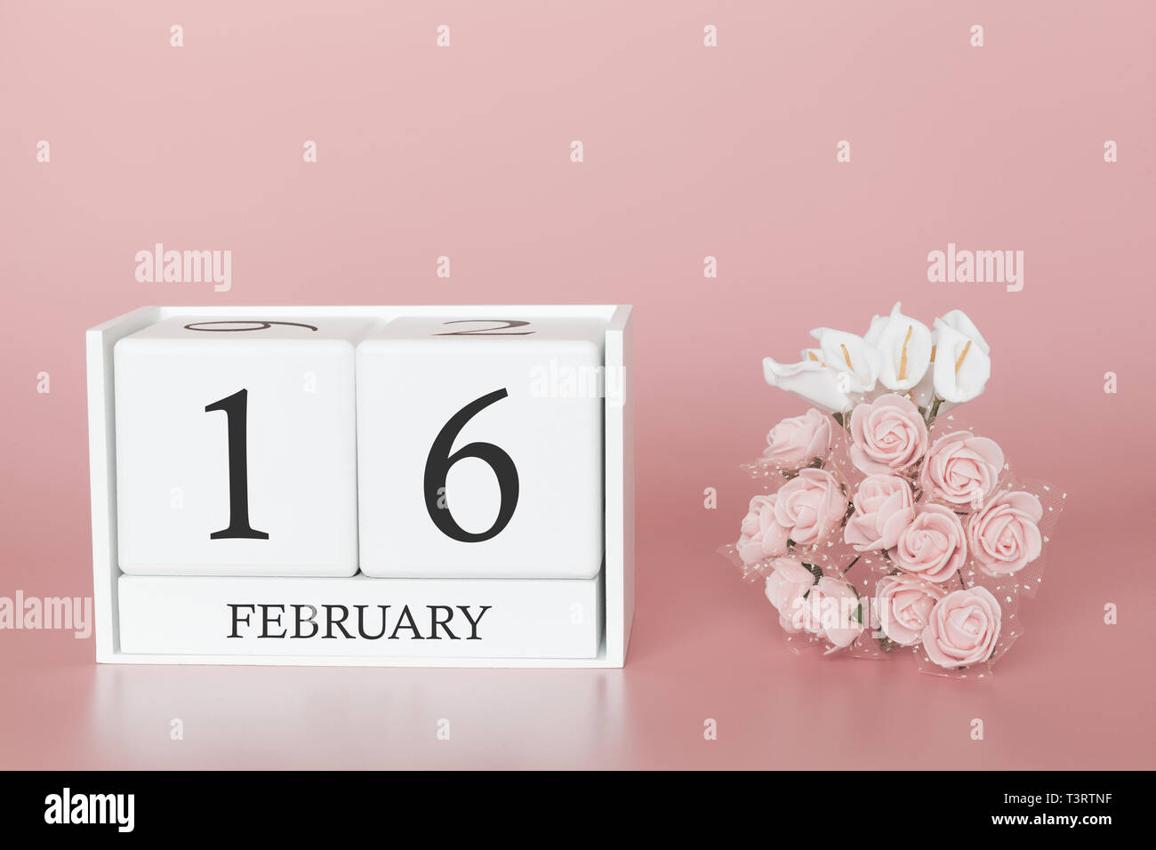 February 16th. Day 16 of month. Calendar cube on modern pink background ...