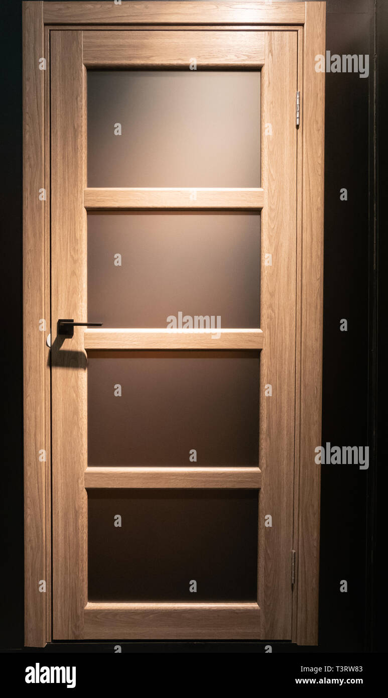 closeup of wooden home room door with few matt glass window frames ...