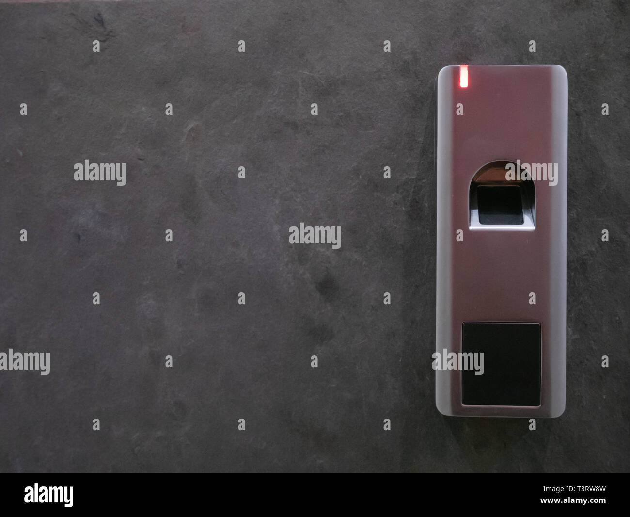 closeup of grey stone entrance door with security fingerprint scanner ...