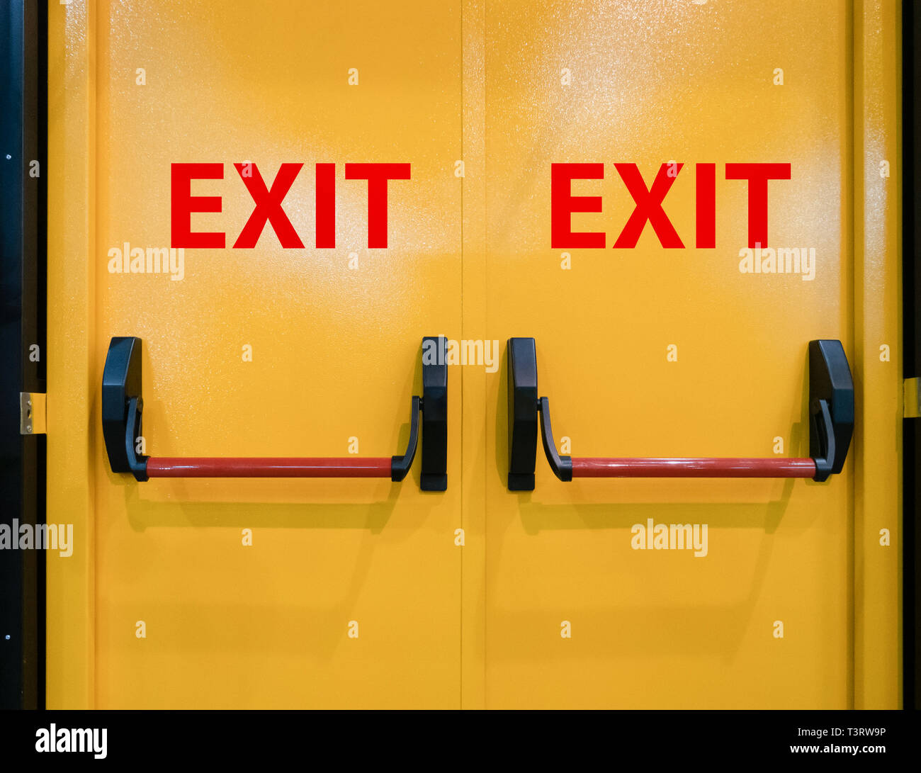 closeup bright vivid yellow double doors for emergency exit Stock Photo ...