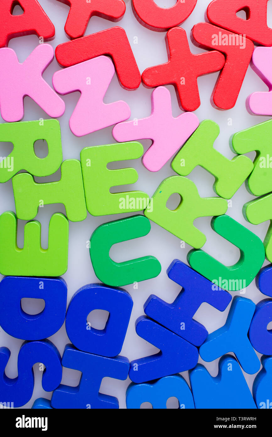 Colorful alphabet letter blocks scattered randomly on white background ...