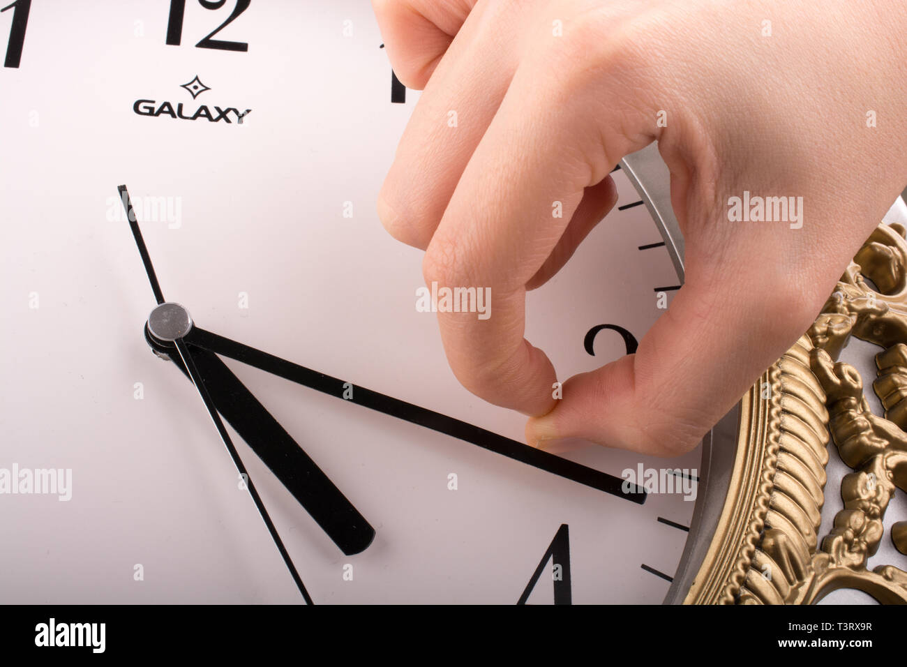 hand in touch with a clock on a white background Stock Photo - Alamy