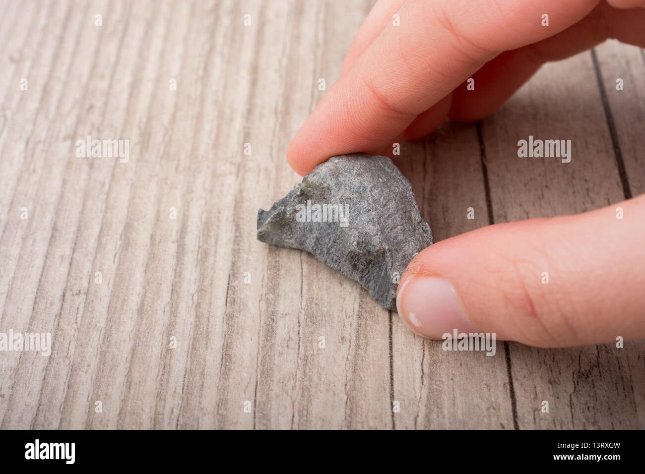 Hand holding little stone in hi-res stock photography and images - Alamy