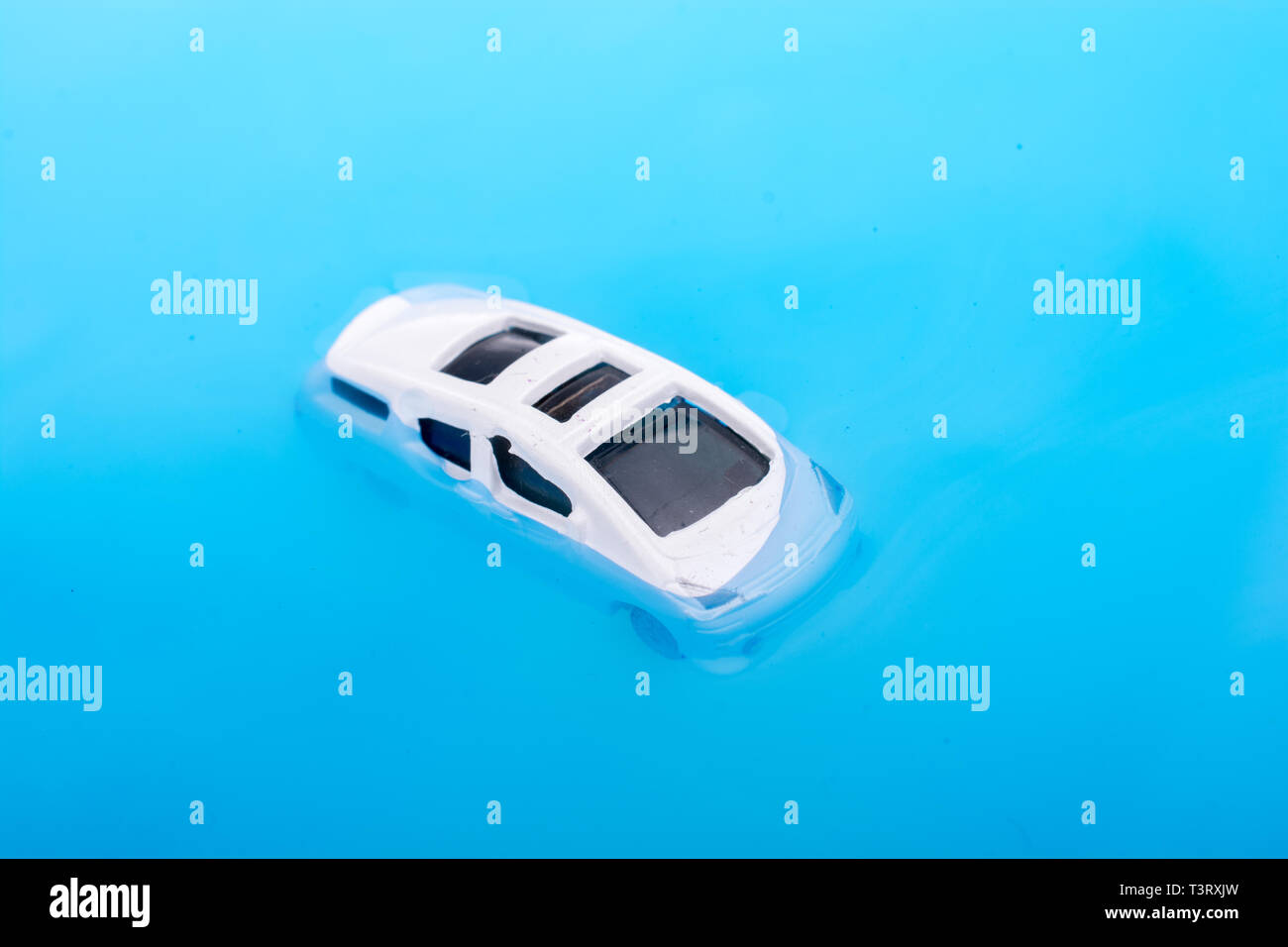Little toy car floats in blue water Stock Photo - Alamy