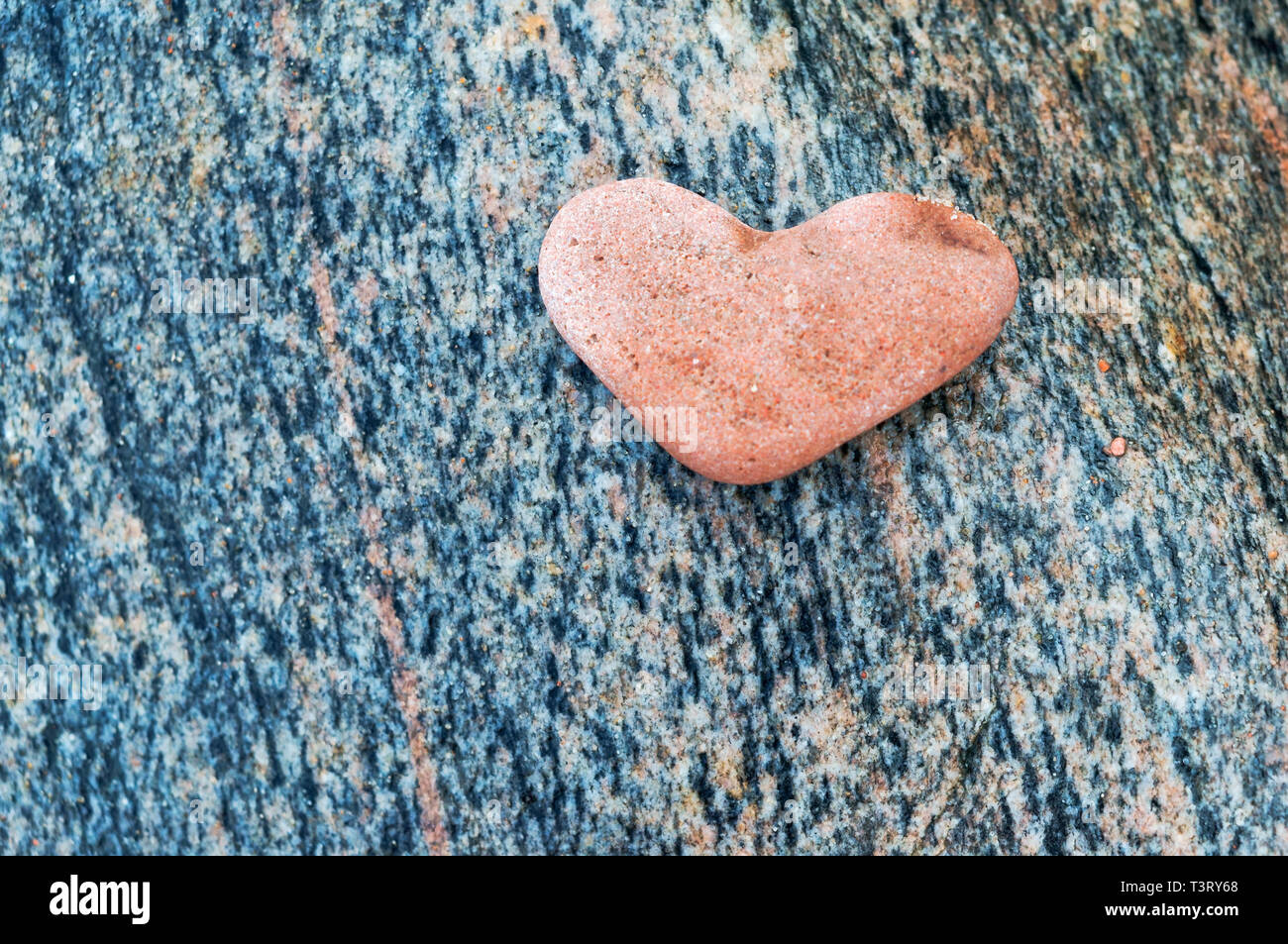 red stone heart, heart-shaped stone on dark background Stock Photo - Alamy