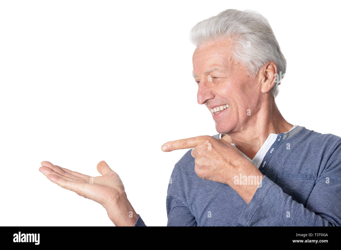 Portrait of happy senior man pointing to the left isolated on white ...
