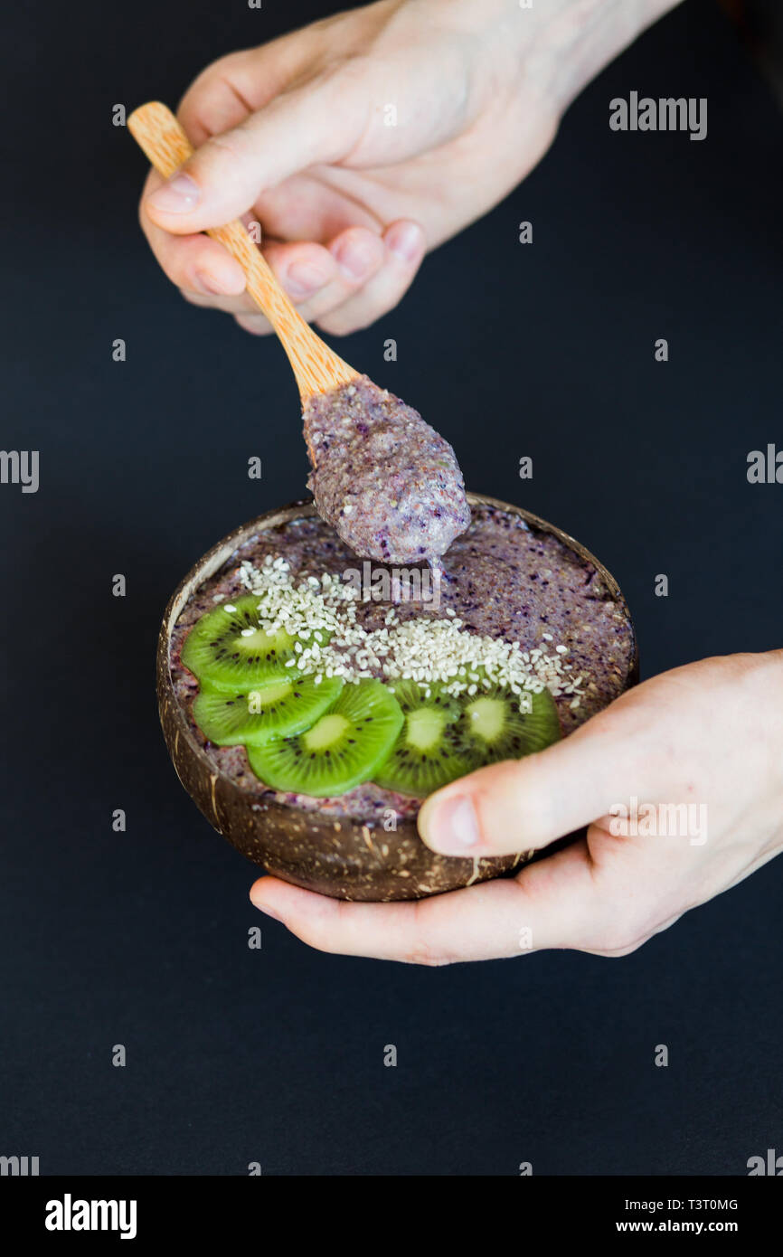 Healthy smoothie with fruits, plate made from coconut shell and wood ...