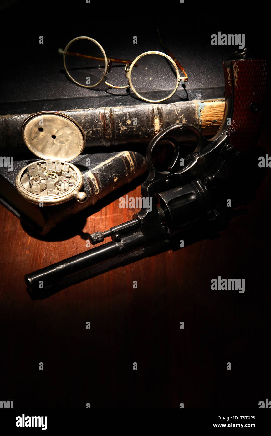 Vintage still life with revolver and spectacles near old books Stock ...