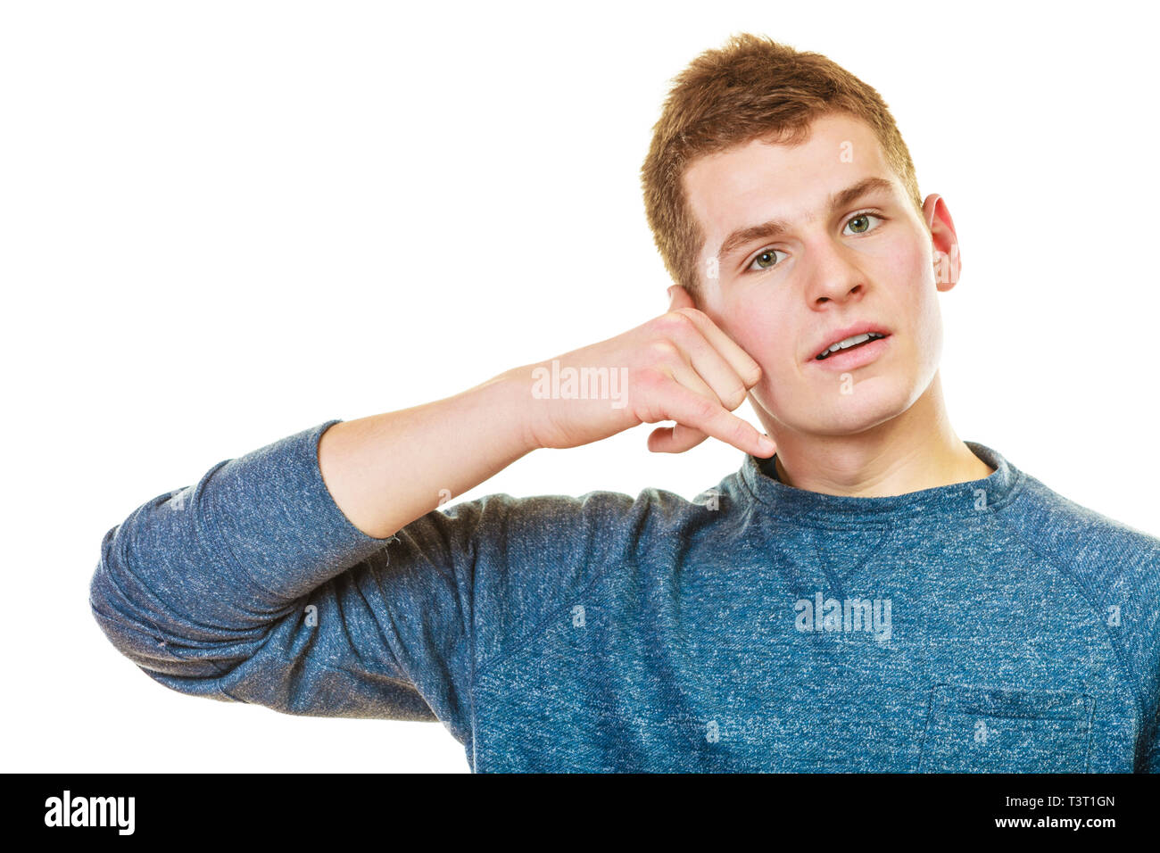 Communication concept. Young man making call me gesture. Blonde teen ...