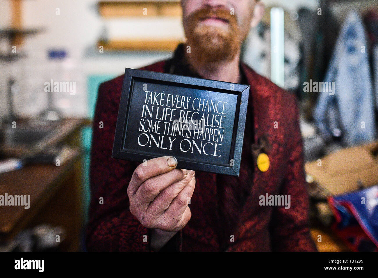 A man known as 'Slovakian Rich' holds a sign he has inside his shipping ...