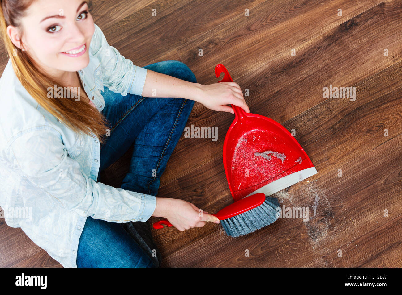 Cleanup housework concept. cleaning woman sweeping wooden floor with ...