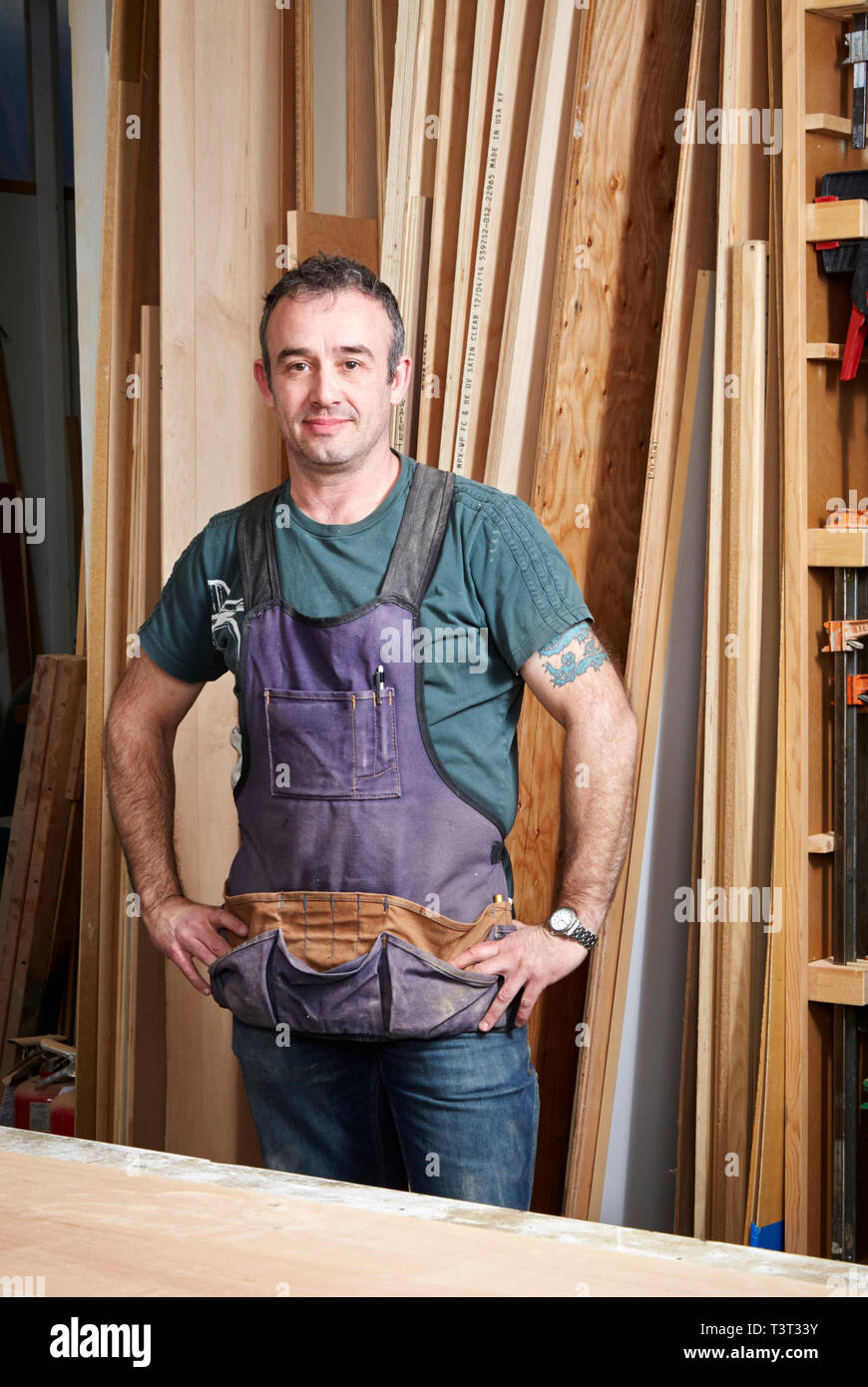 Carpenter smiling in workshop Stock Photo - Alamy