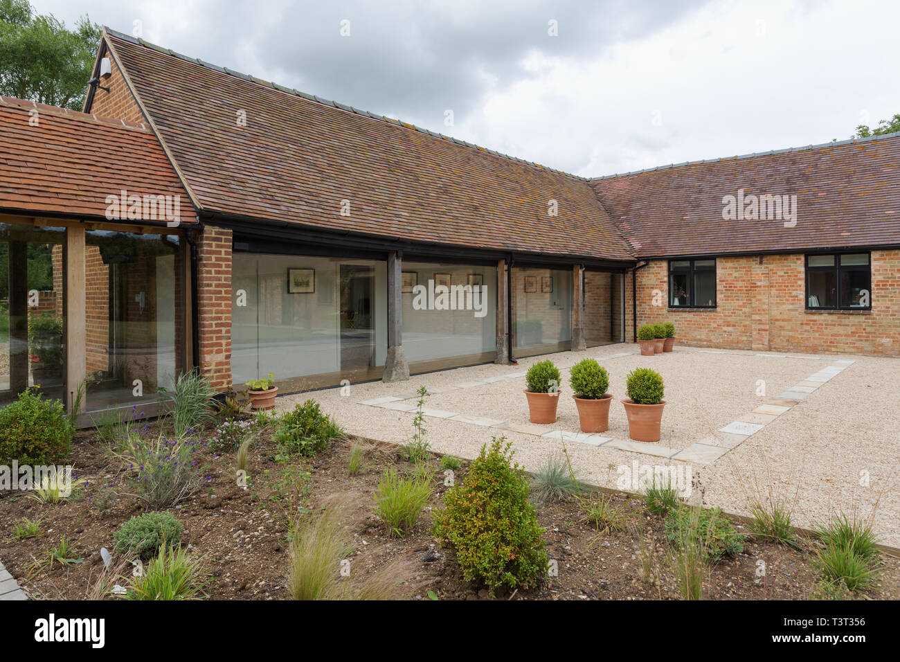 Courtyard of converted barn home Stock Photo - Alamy