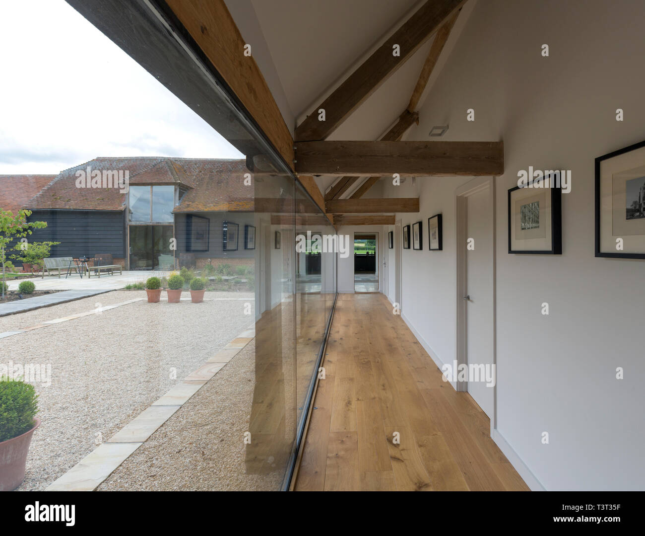 Glass wall and hallway of modern home Stock Photo - Alamy