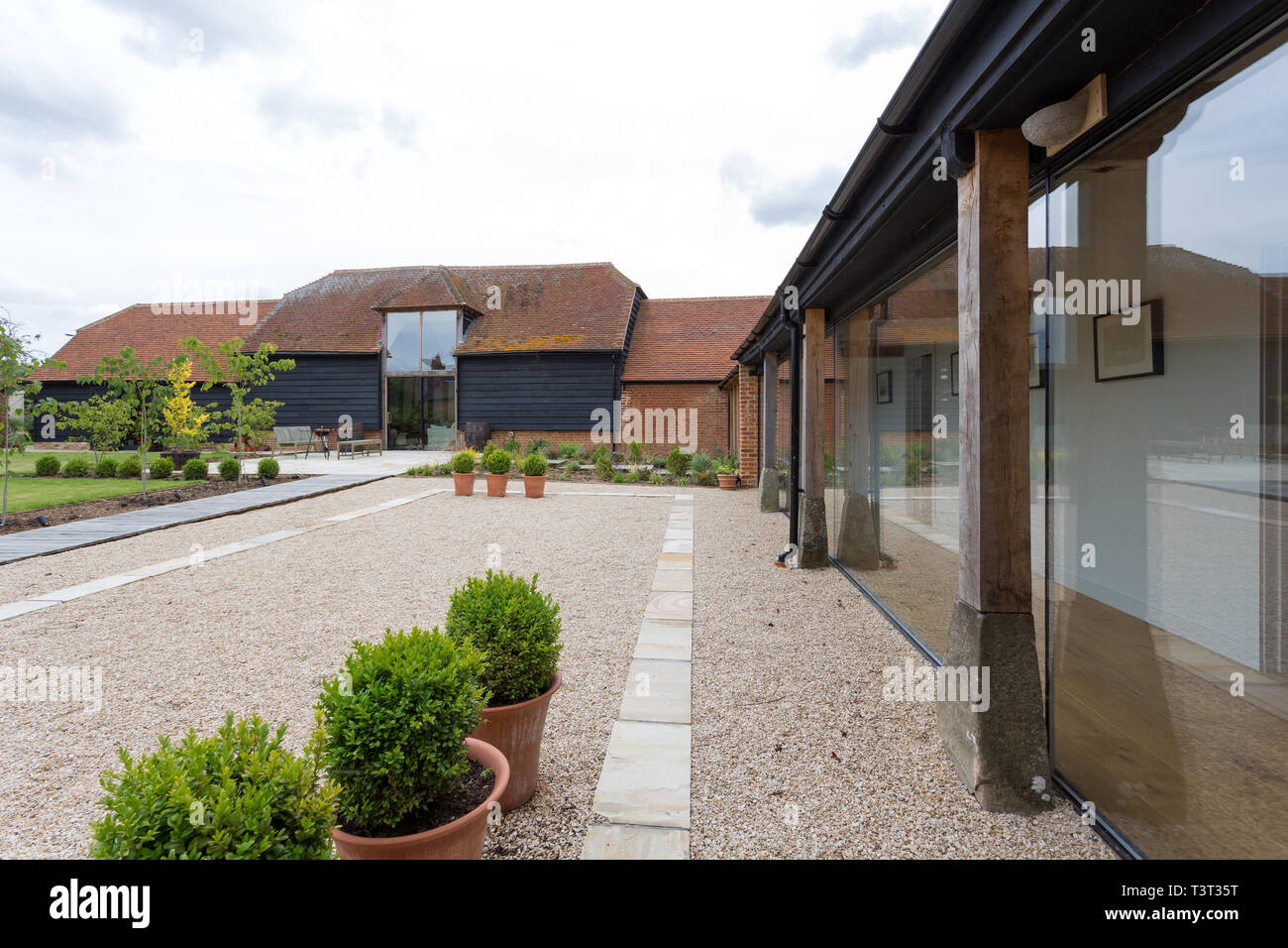 Courtyard of converted barn home Stock Photo - Alamy