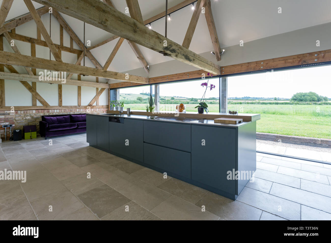 Breakfast bar and glass wall in modern kitchen Stock Photo - Alamy