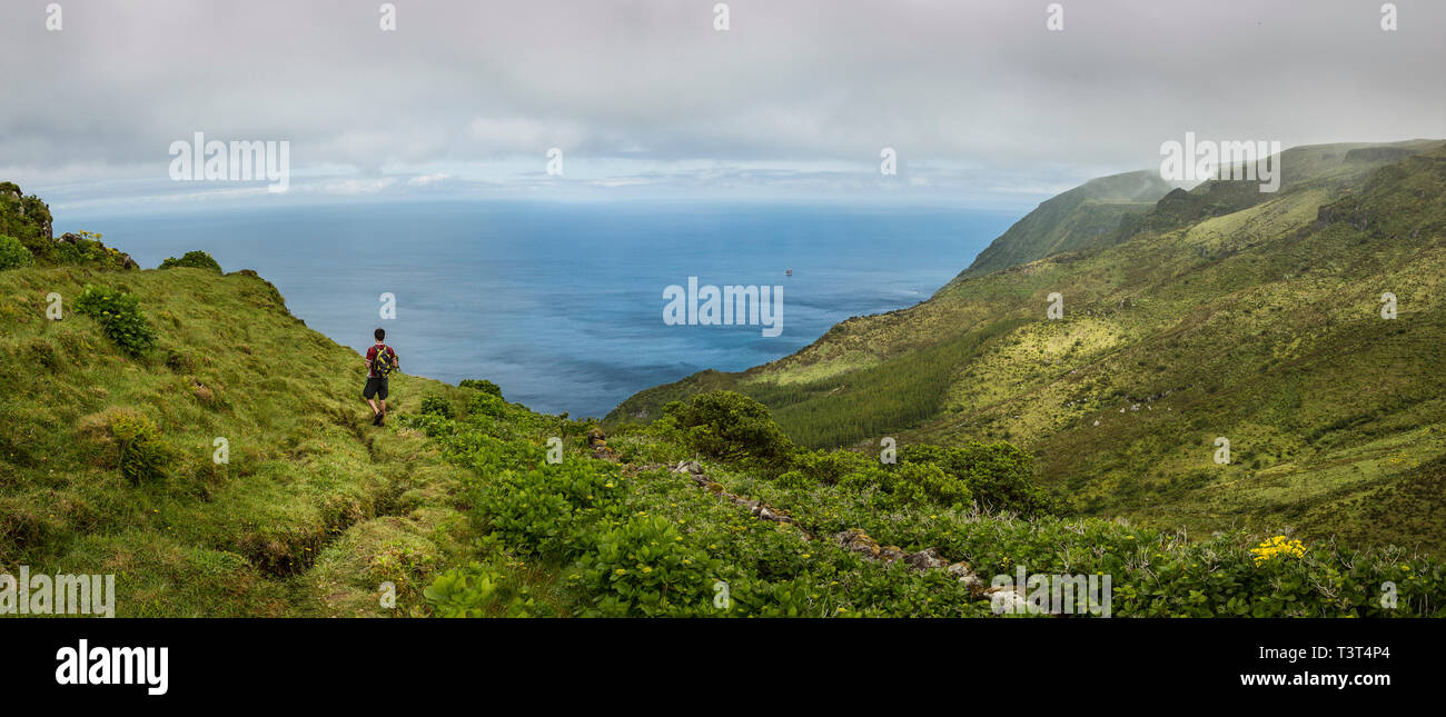 Hiker walking on hilltop path in rural landscape Stock Photo - Alamy