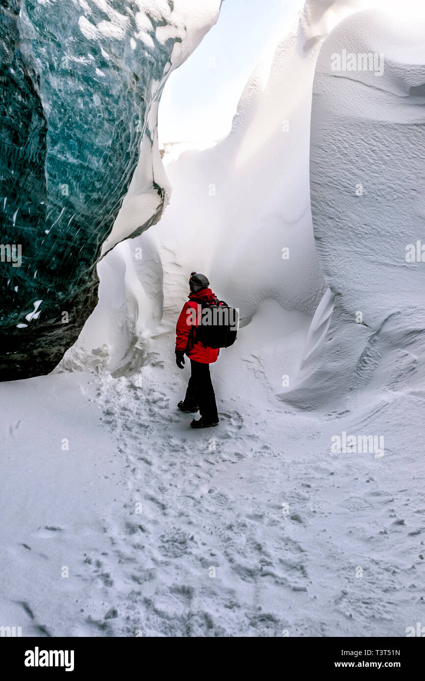 Hiker walking in snowy ice cave Stock Photo - Alamy