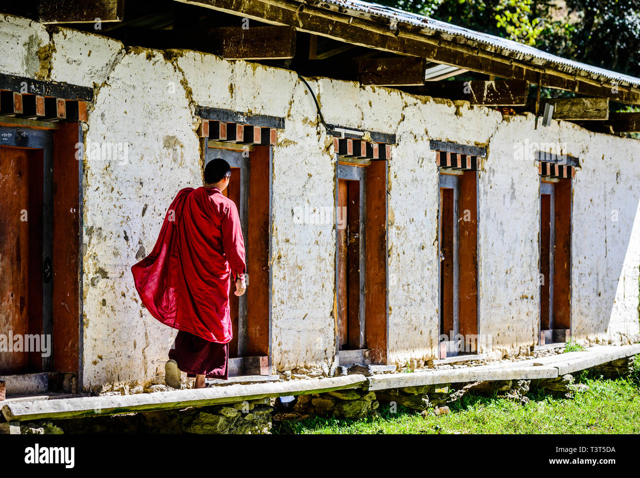 Asian monk walking by monastery doors Stock Photo - Alamy