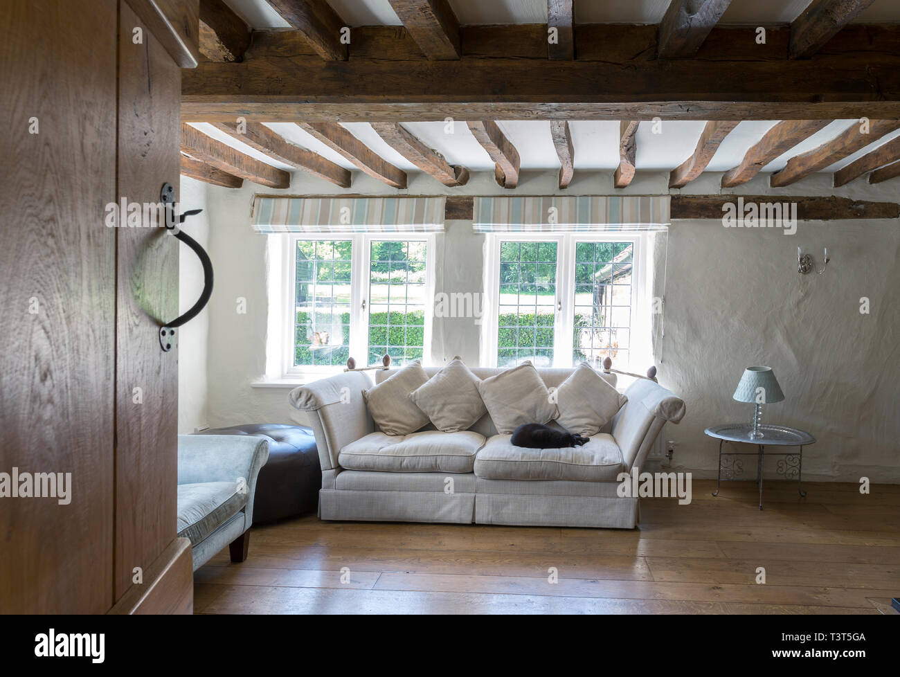 Sofa under beams in living room Stock Photo - Alamy