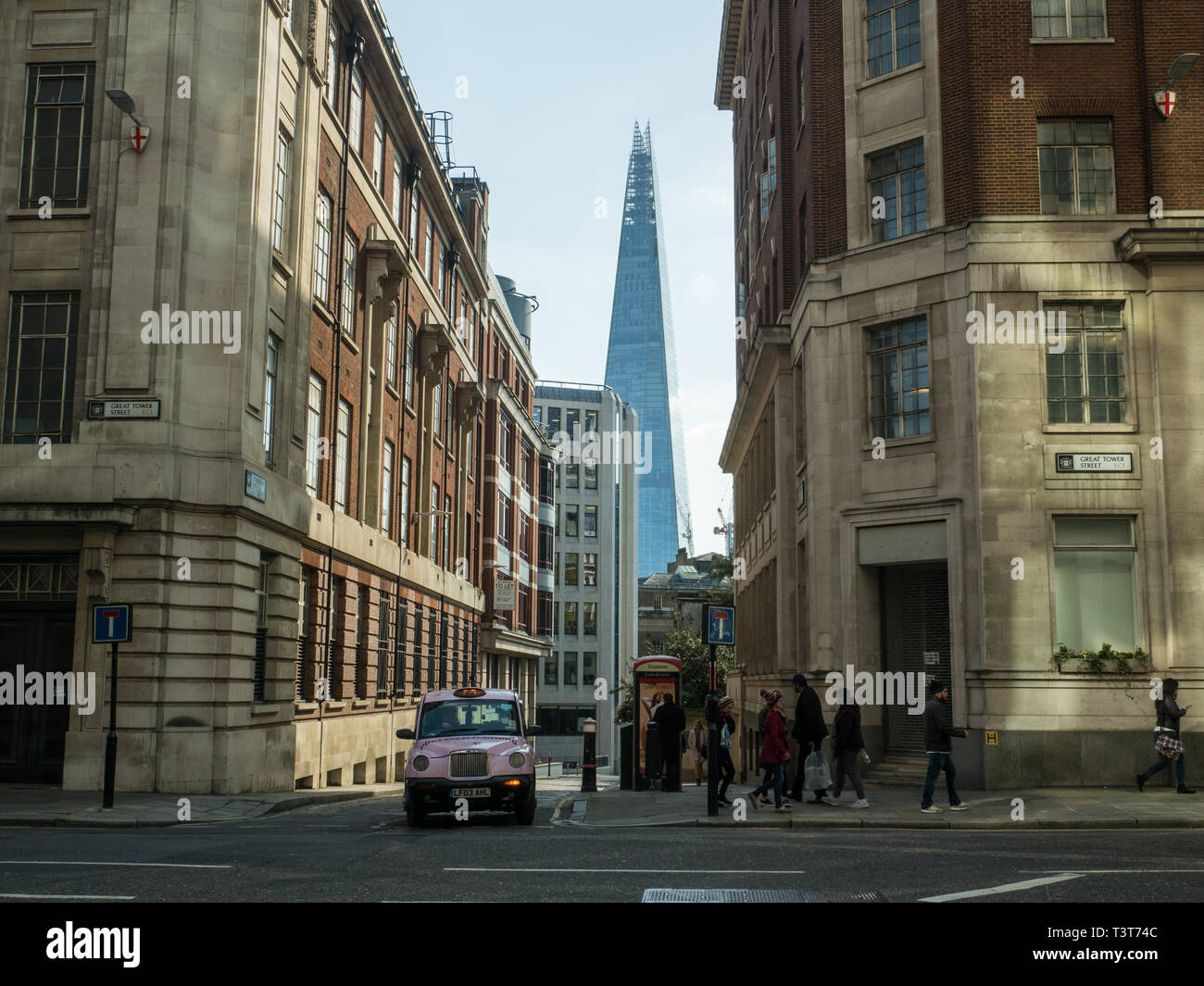 Pink taxi/cab oat a crossroads in London, England, with The Shard ...