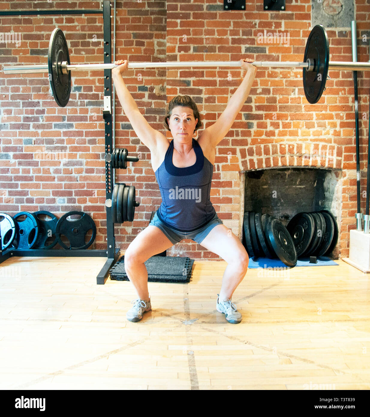 Caucasian woman lifting weights in gymnasium Stock Photo - Alamy