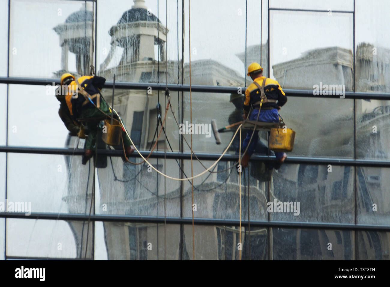 Workers clean the glass facade of a skyscraper in shenzhen, China Stock ...