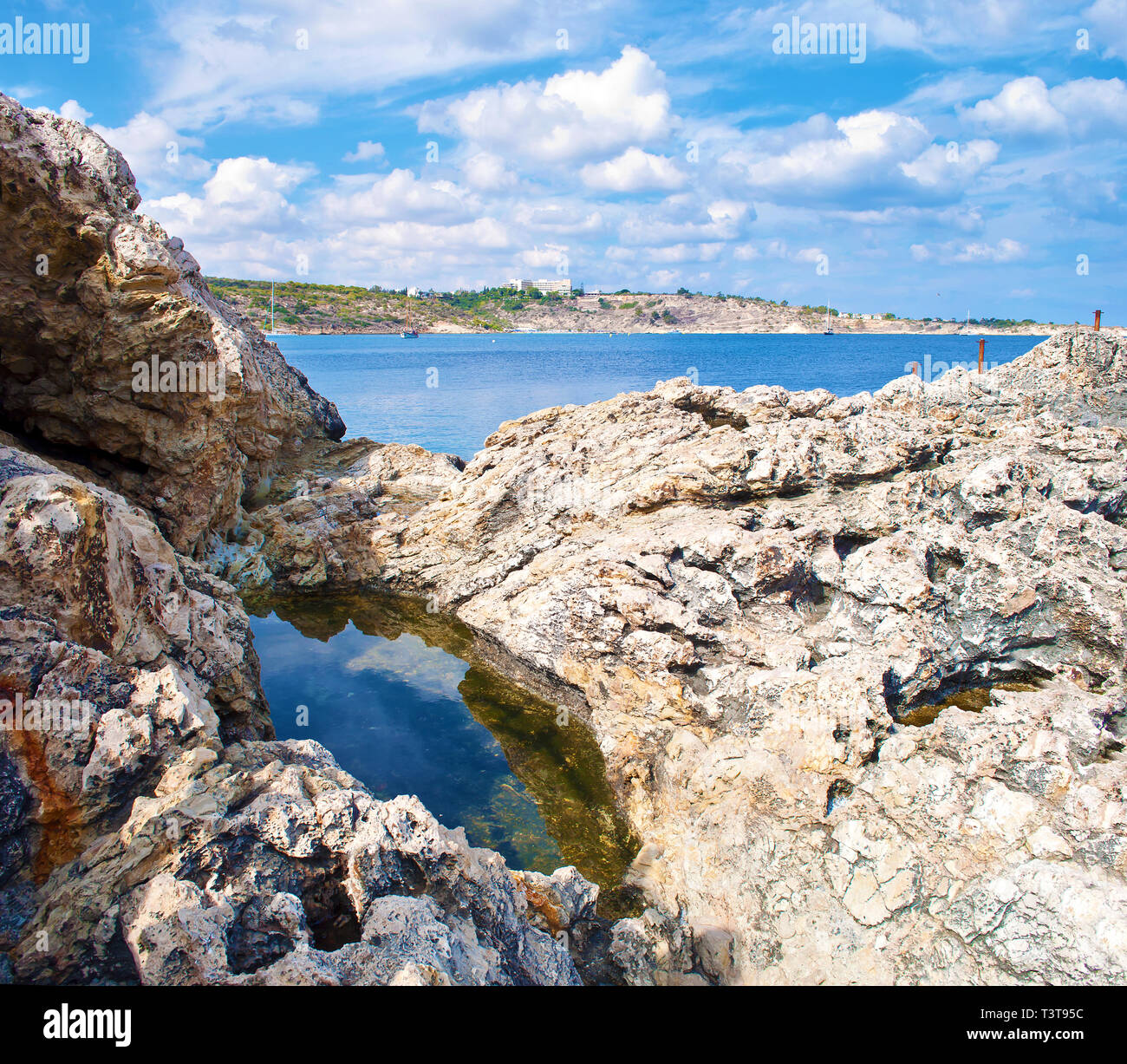 View of a bay near Cape Greco, Cyprus. Rock coastline near deep blue ...