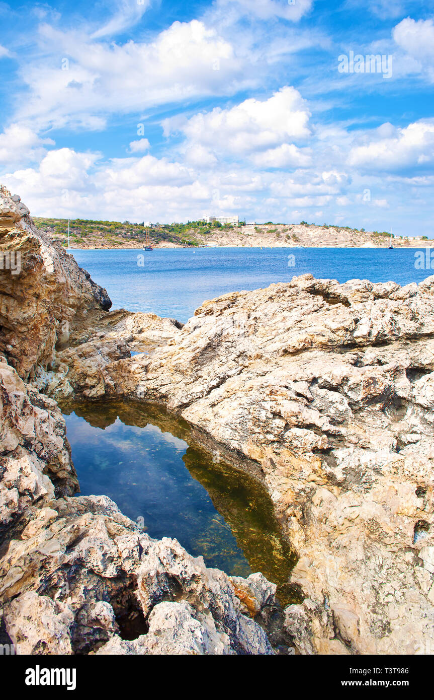 View of a bay near Cape Greco, Cyprus. Rock coastline near deep blue ...