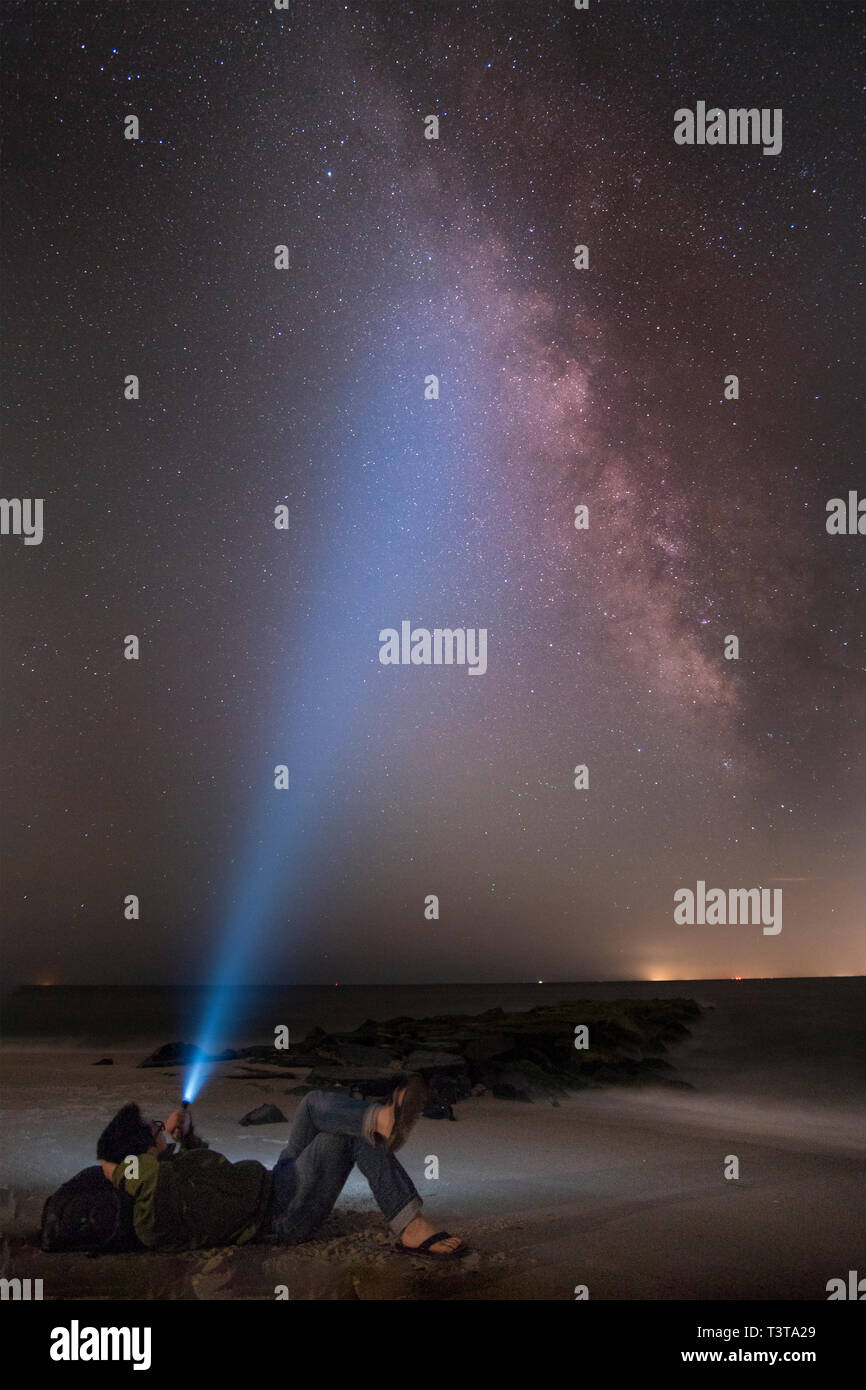 Person shining a light into the night sky hi-res stock photography and ...