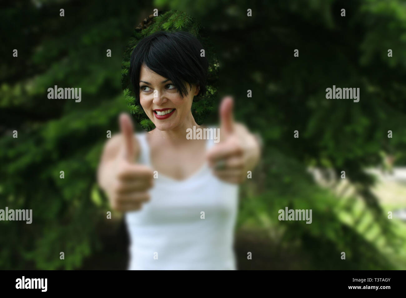 Beautiful dark haired lady with a white top making hand signals. thumbs ...