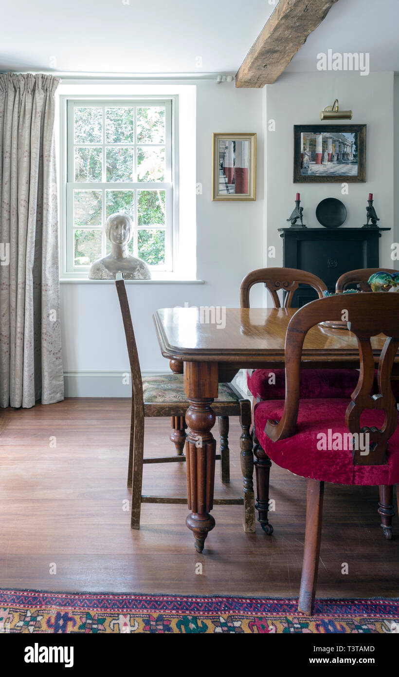 Bust on window near dining table Stock Photo - Alamy