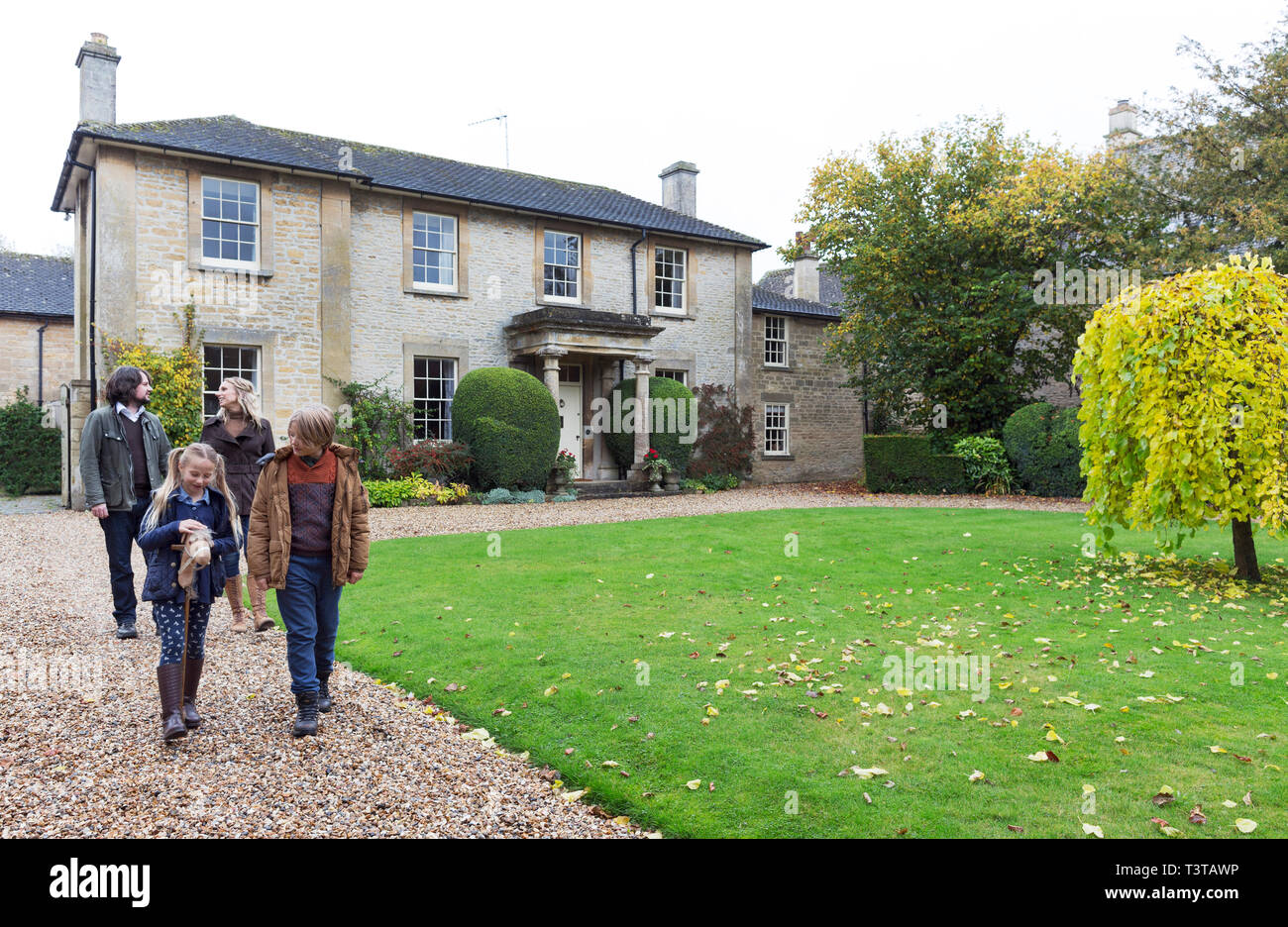 Caucasian family walking on driveway Stock Photo - Alamy