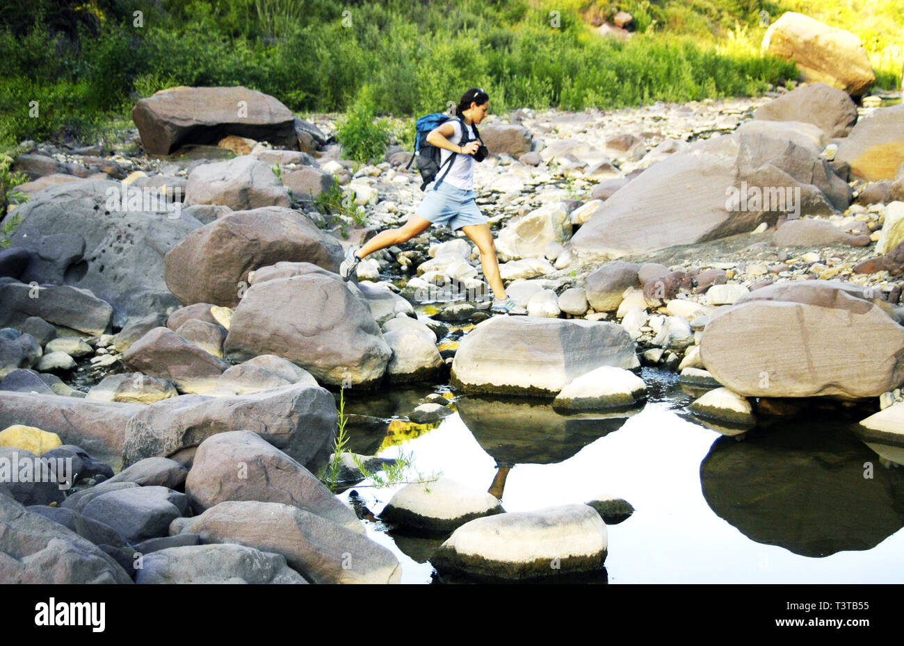 Woman leaping rocks hi-res stock photography and images - Alamy