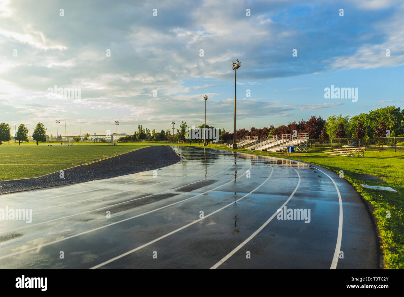 Wet bleachers and running track Stock Photo - Alamy