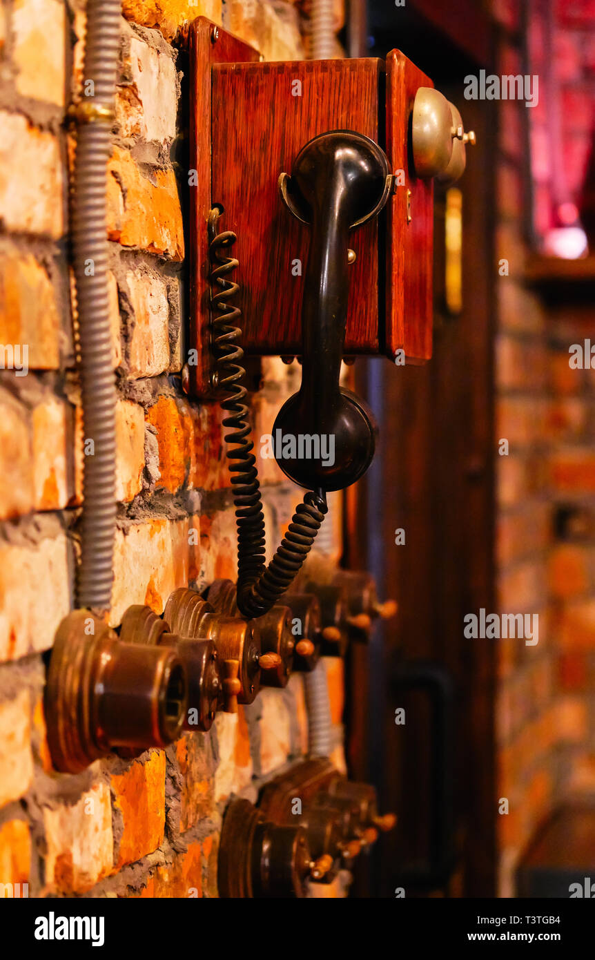 Side vertical view telephone and turning on off lighting switches in a ...