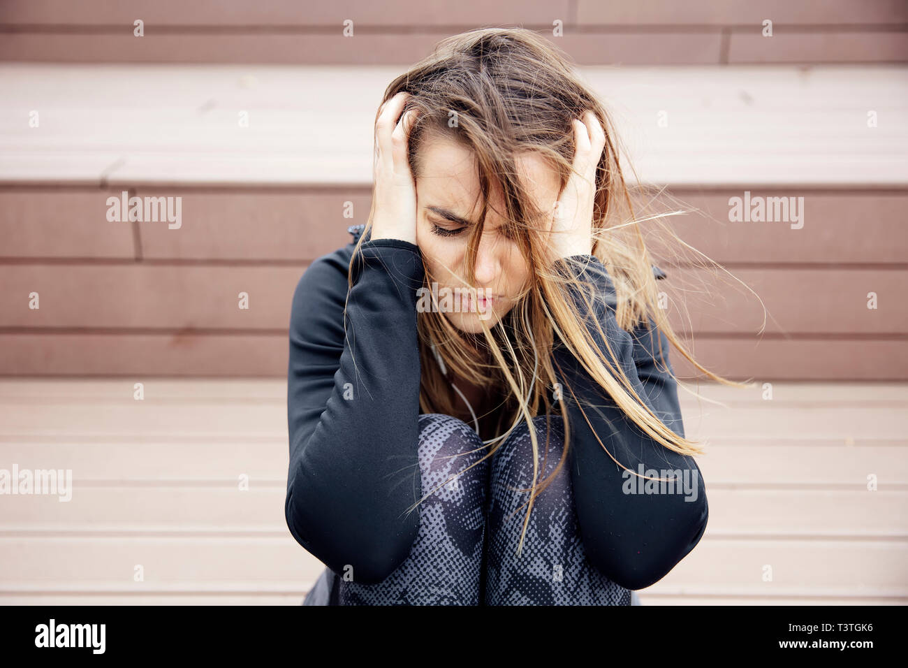 Portrait of angry sad young woman sitting outdoor Stock Photo - Alamy