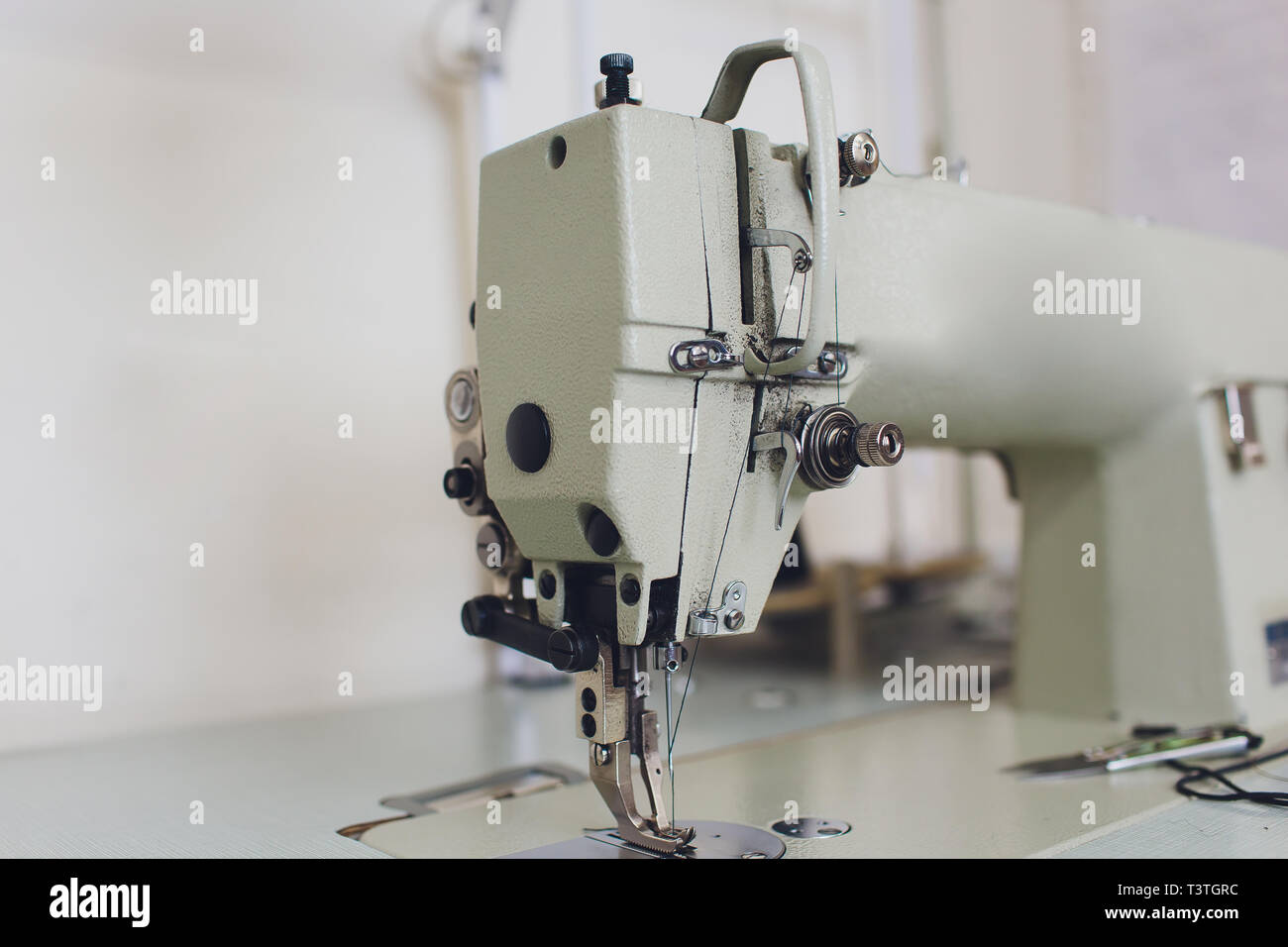Professional sewing machine on the background of atelier studio ...