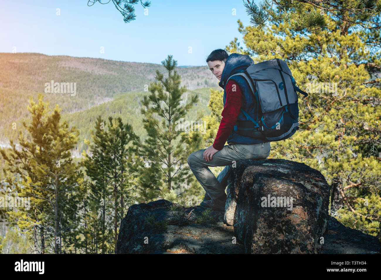 Back view of man standing on rock looking at horizon hi-res stock ...